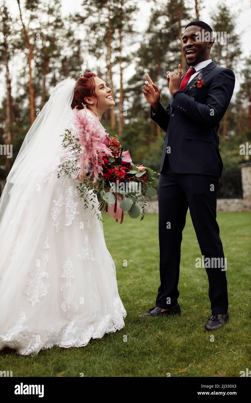 Overjoyed couple dancing, handsome African American man with lovely ...