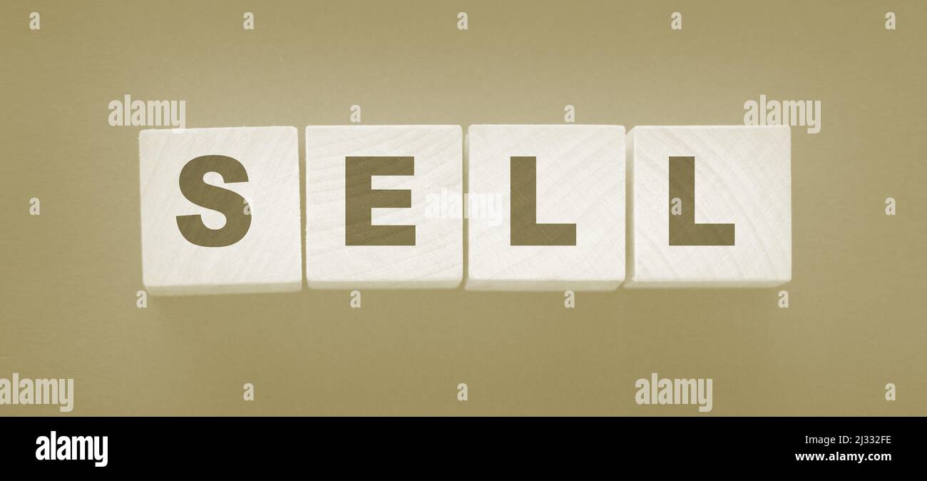 Wooden cubes with word sell on the dark background. Shopping concept ...