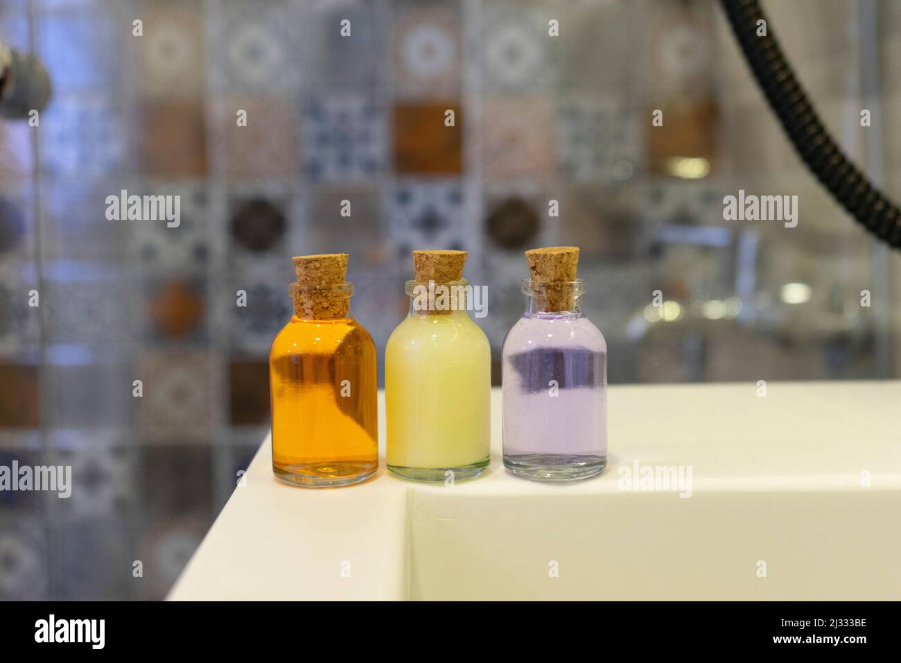 Small, colored shampoo bottles Stock Photo - Alamy