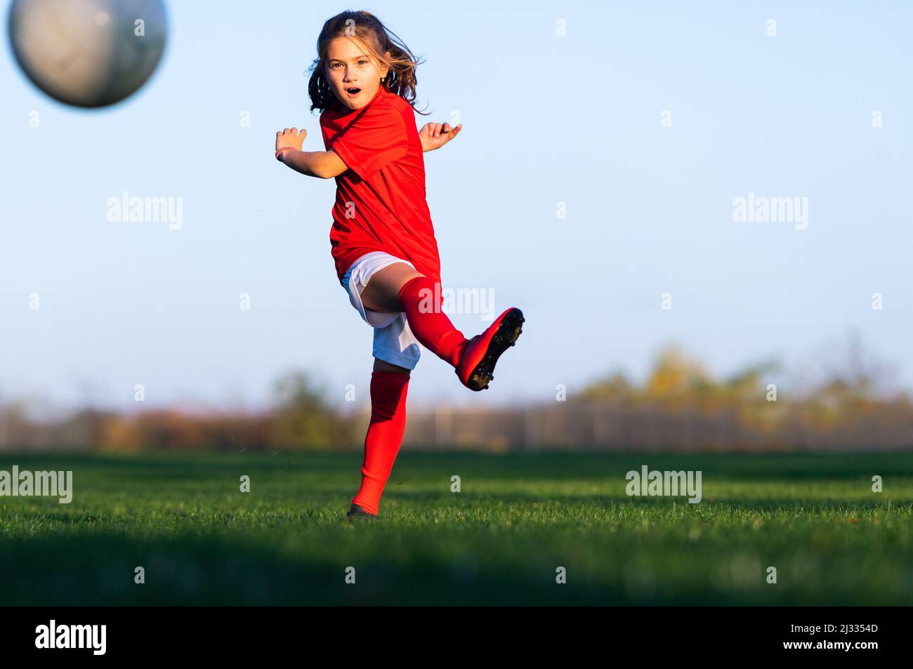 Little girl is training in indoor soccer field Stock Photo - Alamy