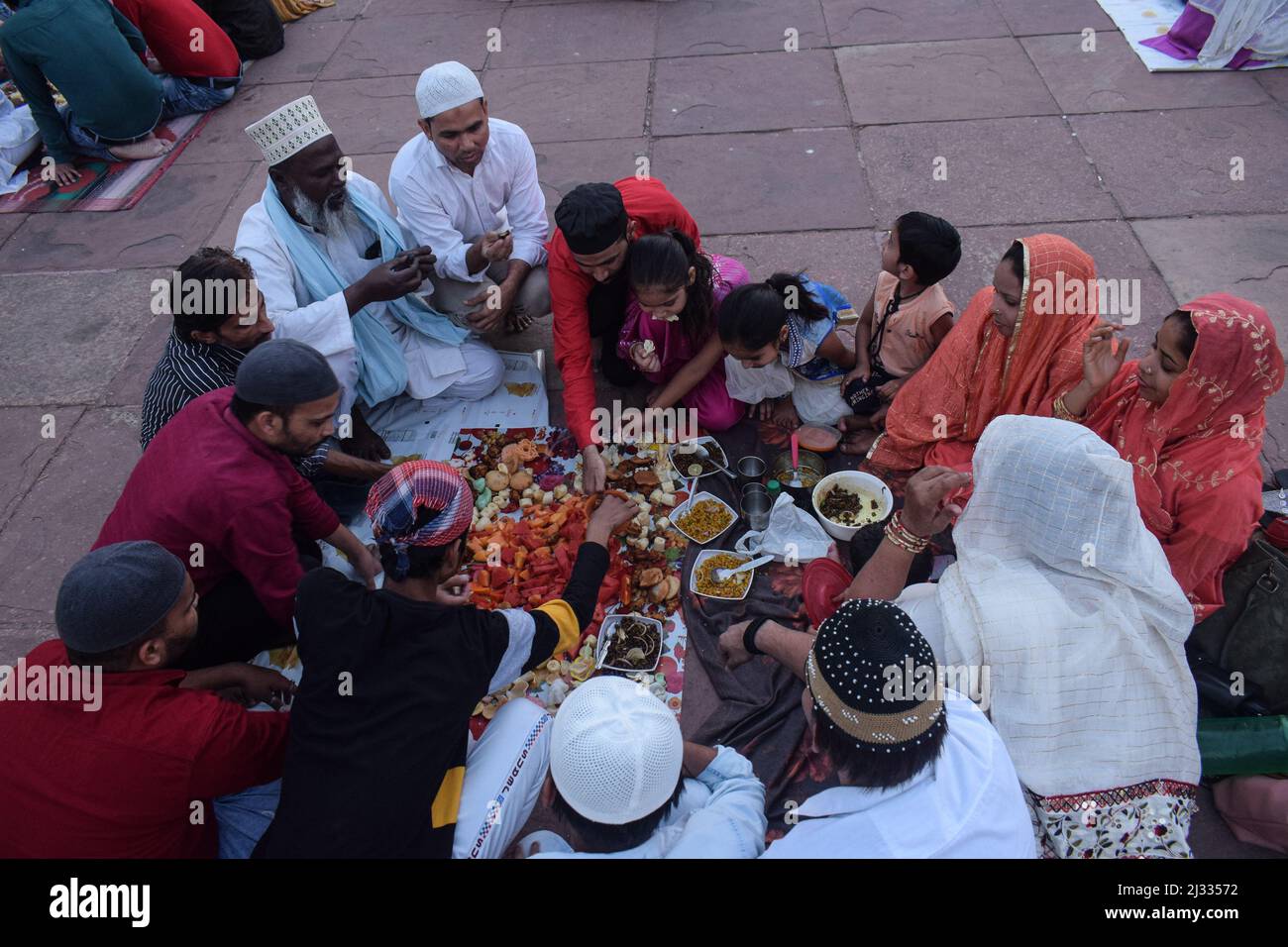 Muslim Devotees Have Food As They Break Their Fast At The Jama Masjid