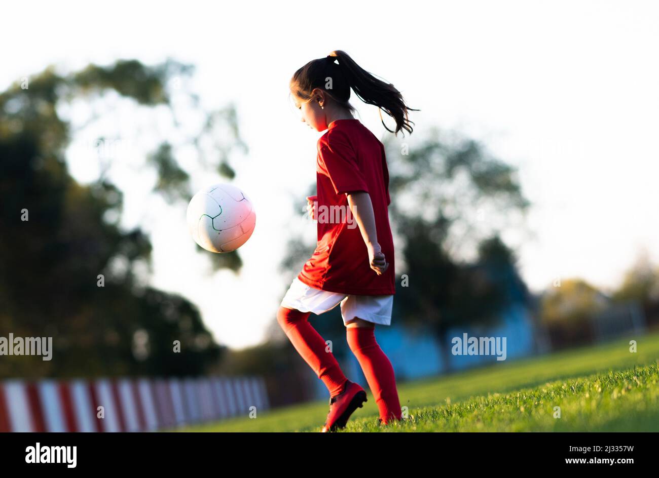 Little girl is training in indoor soccer field Stock Photo - Alamy