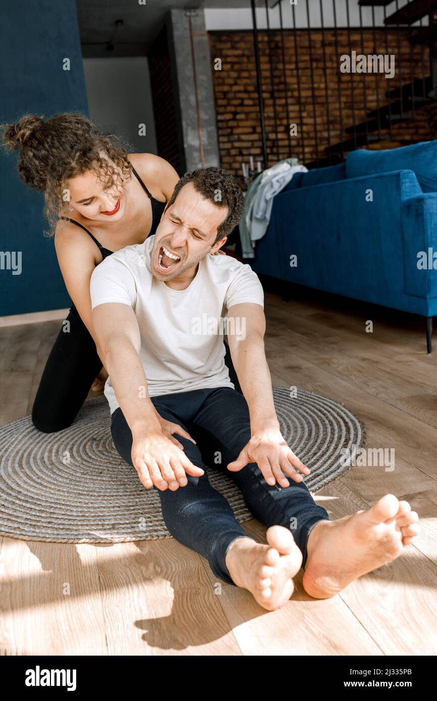 Fit young man doing sport exercise at home with laptop lying on floor ...