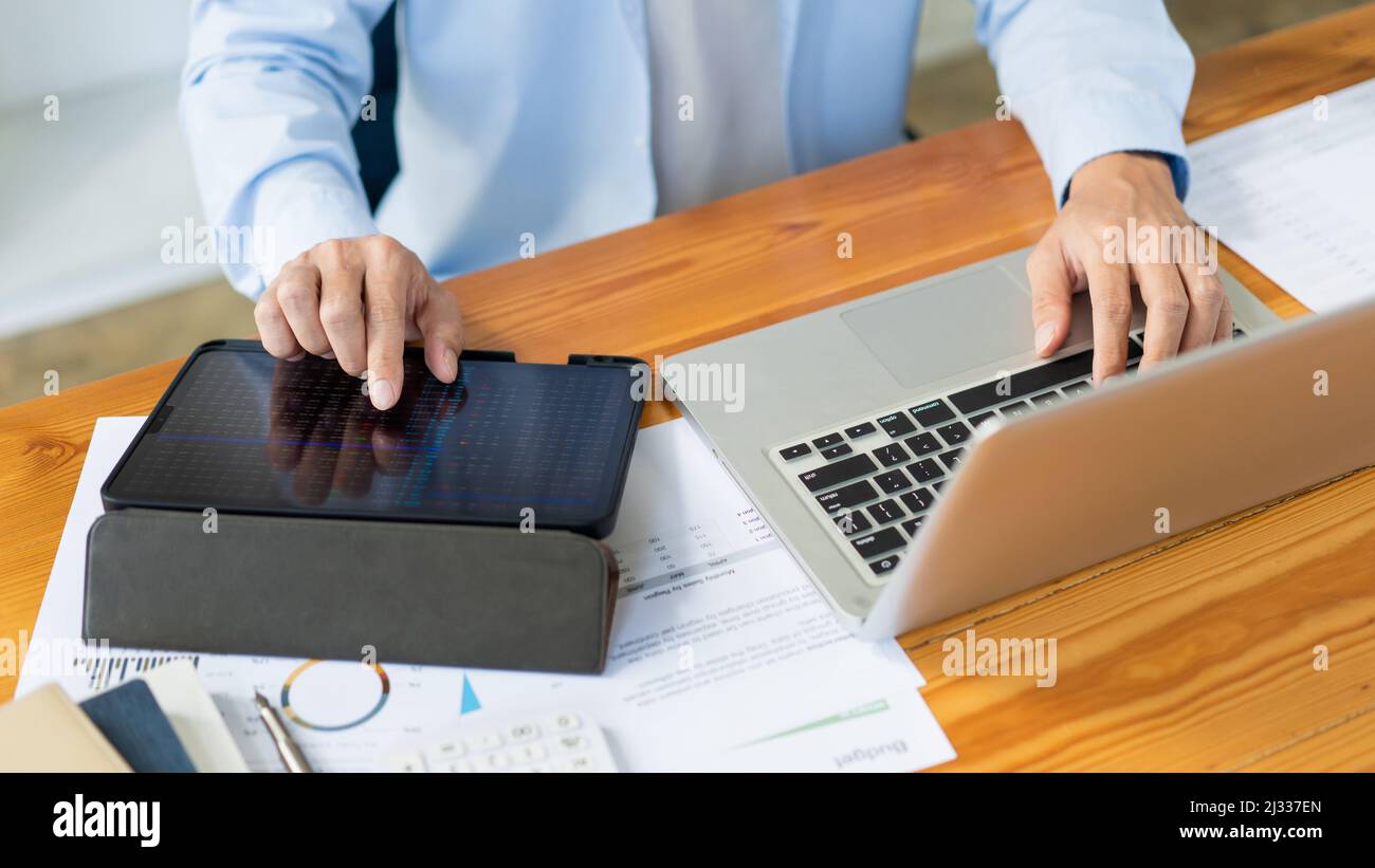 Business analyst concept the businessman using both computer laptop and ...