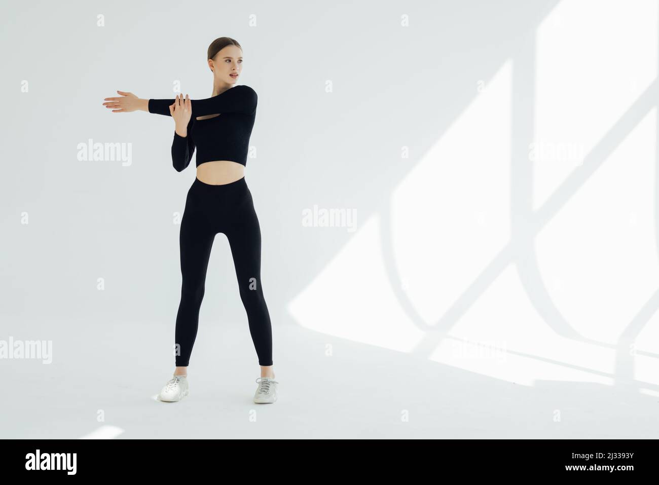 Determined, strong and healthy sports woman, stretching, stretch her ...