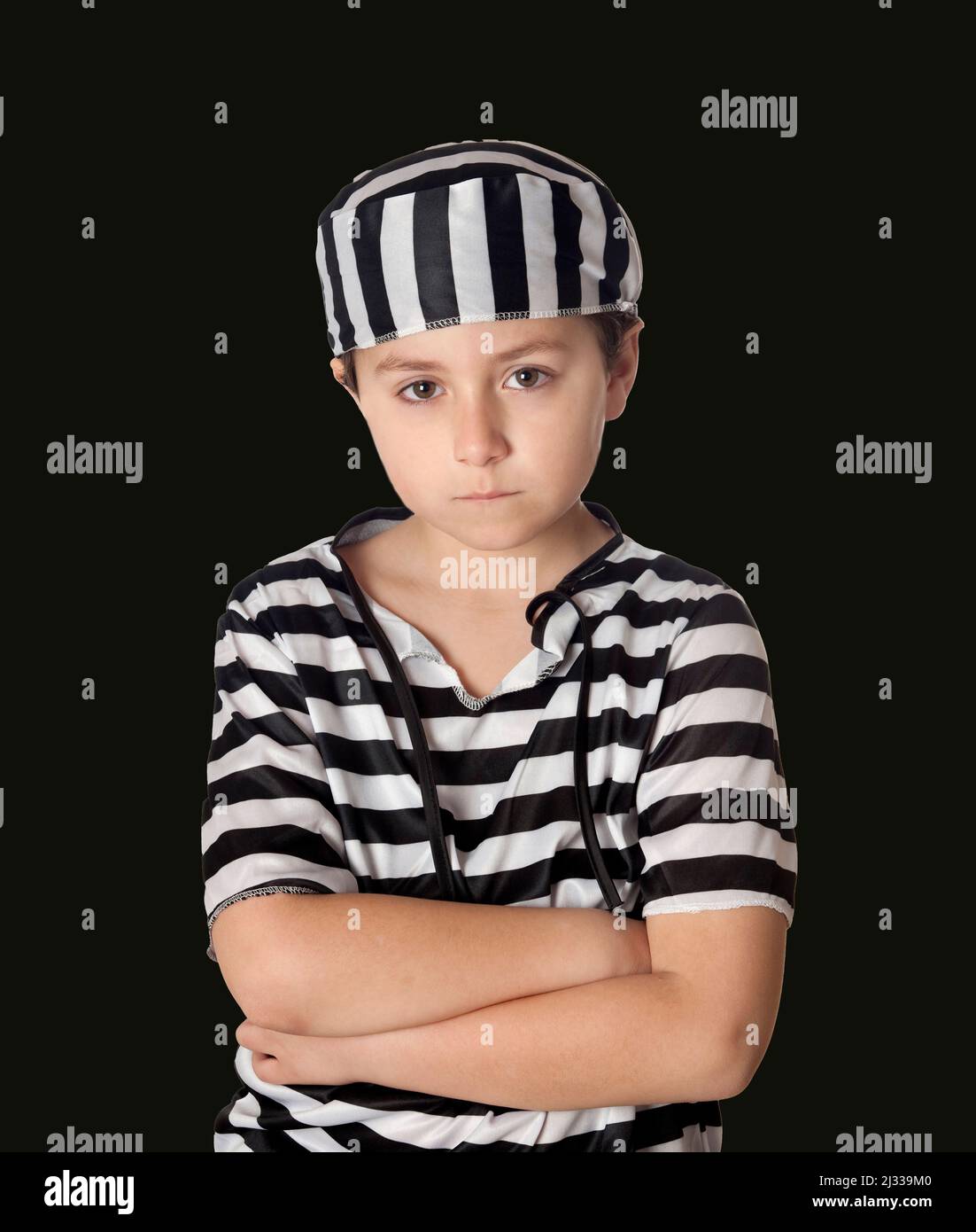 Sad prisoner wearing a striped uniform isolated on a black background ...