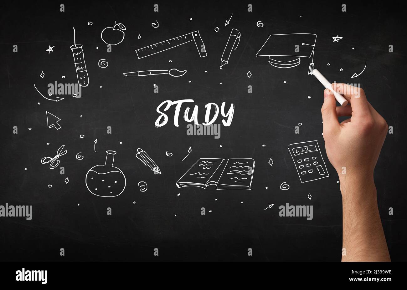 Hand drawing STUDY inscription with white chalk on blackboard ...