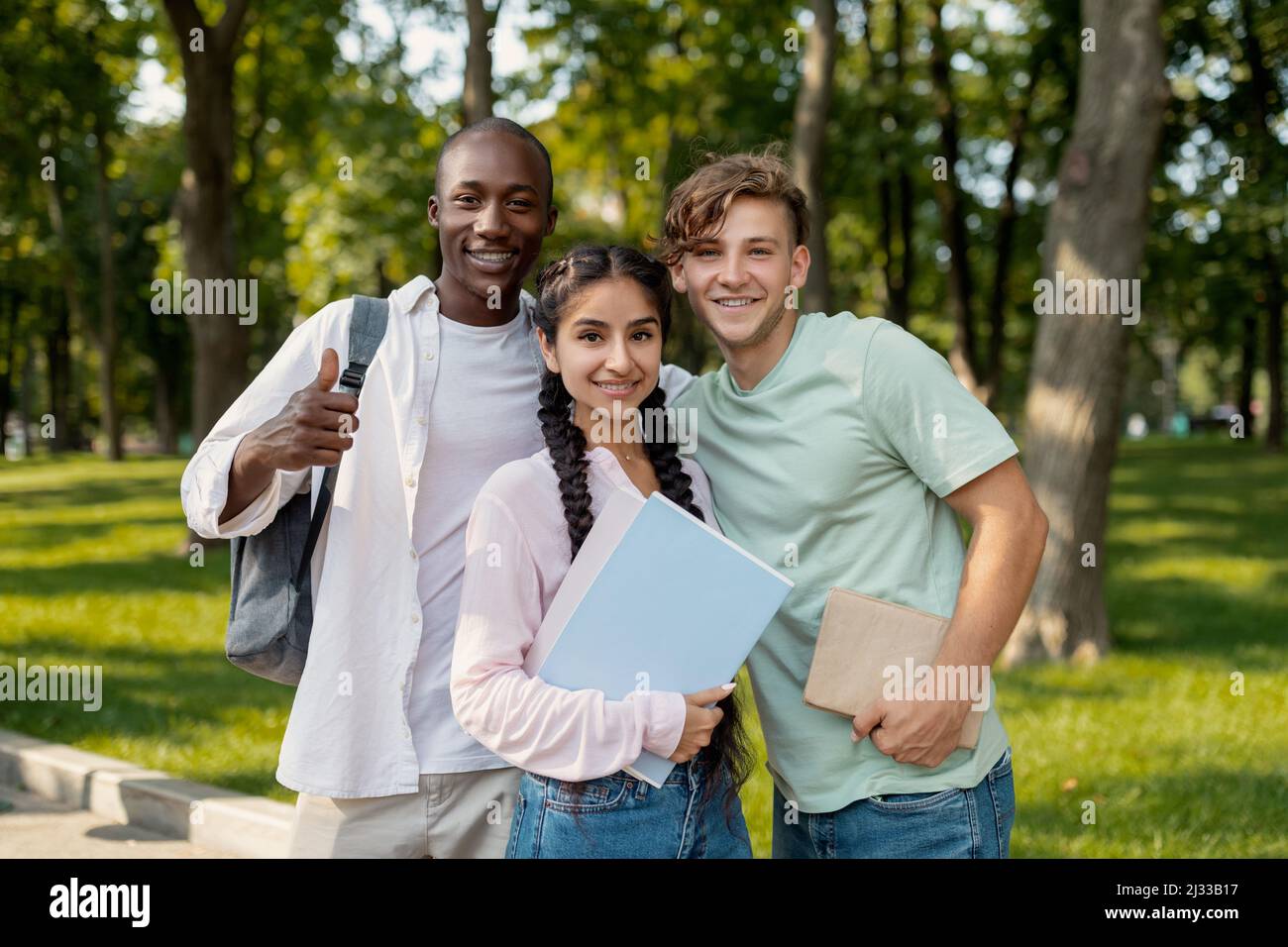 Happy students. Portrait of joyful university friends embracing and ...
