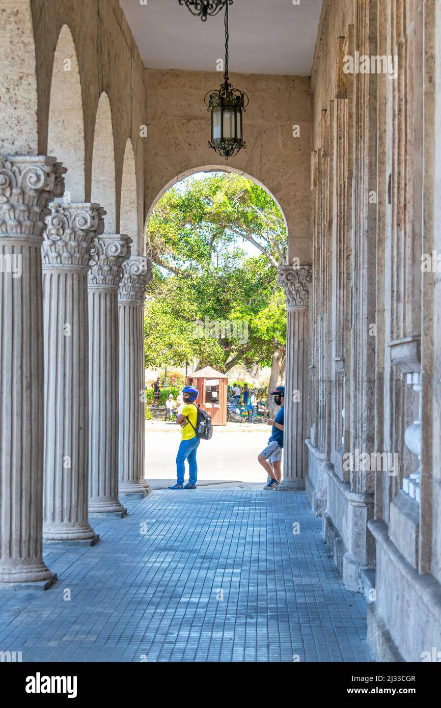 Colonnade with arches supporting a porch of a colonial style building ...
