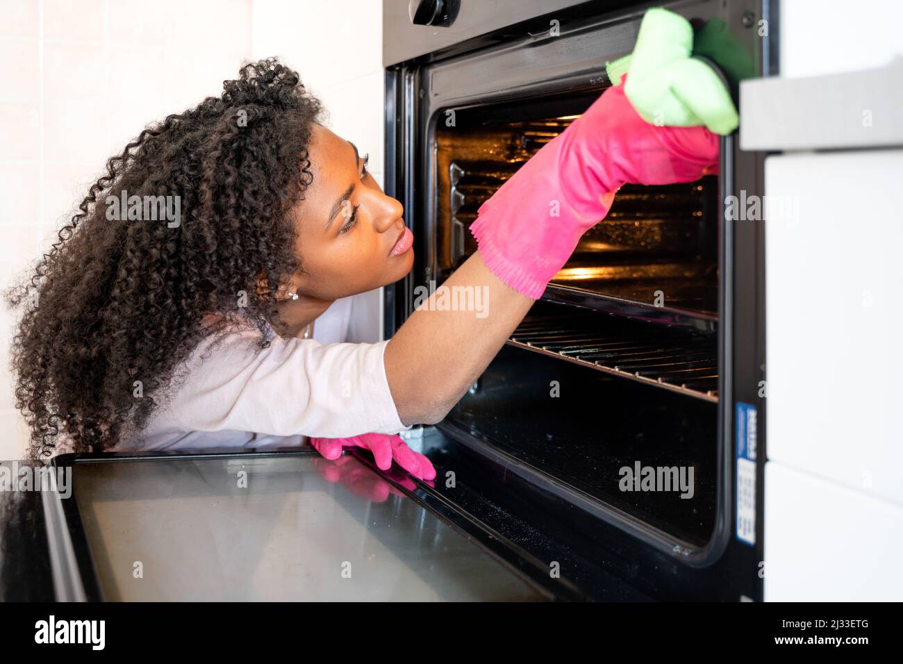 Black female cleaning home hi-res stock photography and images - Alamy