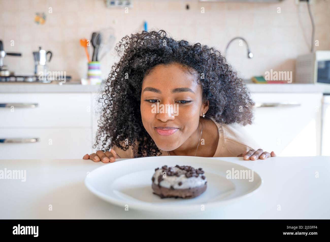 Young woman tempted junk food hi-res stock photography and images - Alamy