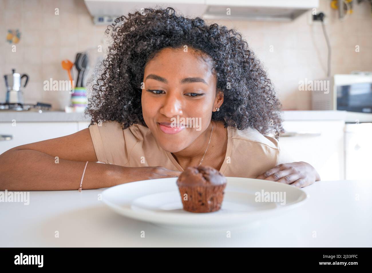 Young woman tempted junk food hi-res stock photography and images - Alamy
