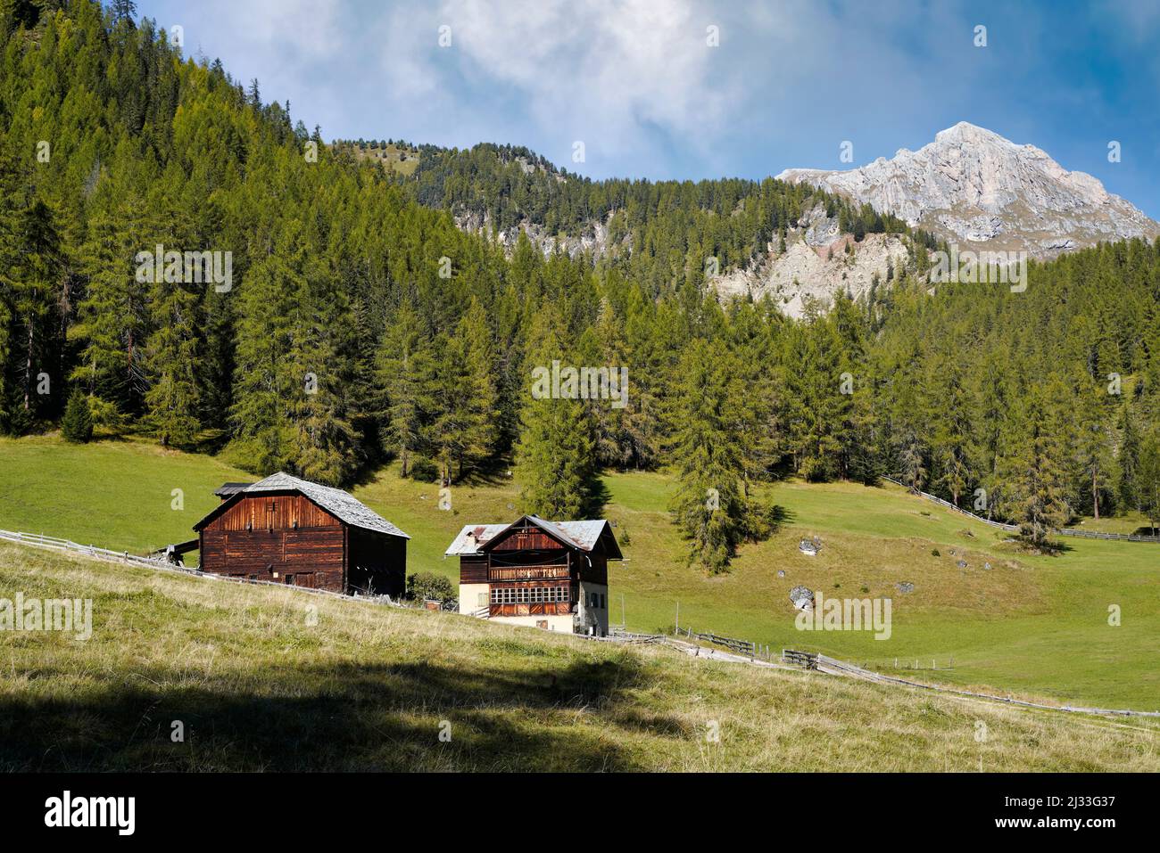 Picturesque mountain farm in front of the impressive backdrop of the ...