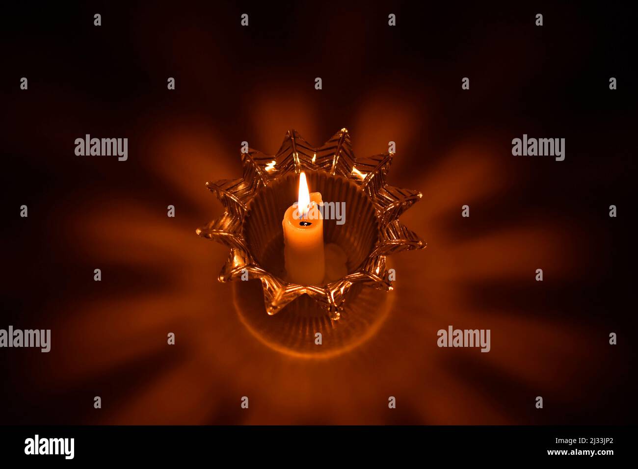 Candle in candlestick, shadows and lights Stock Photo - Alamy