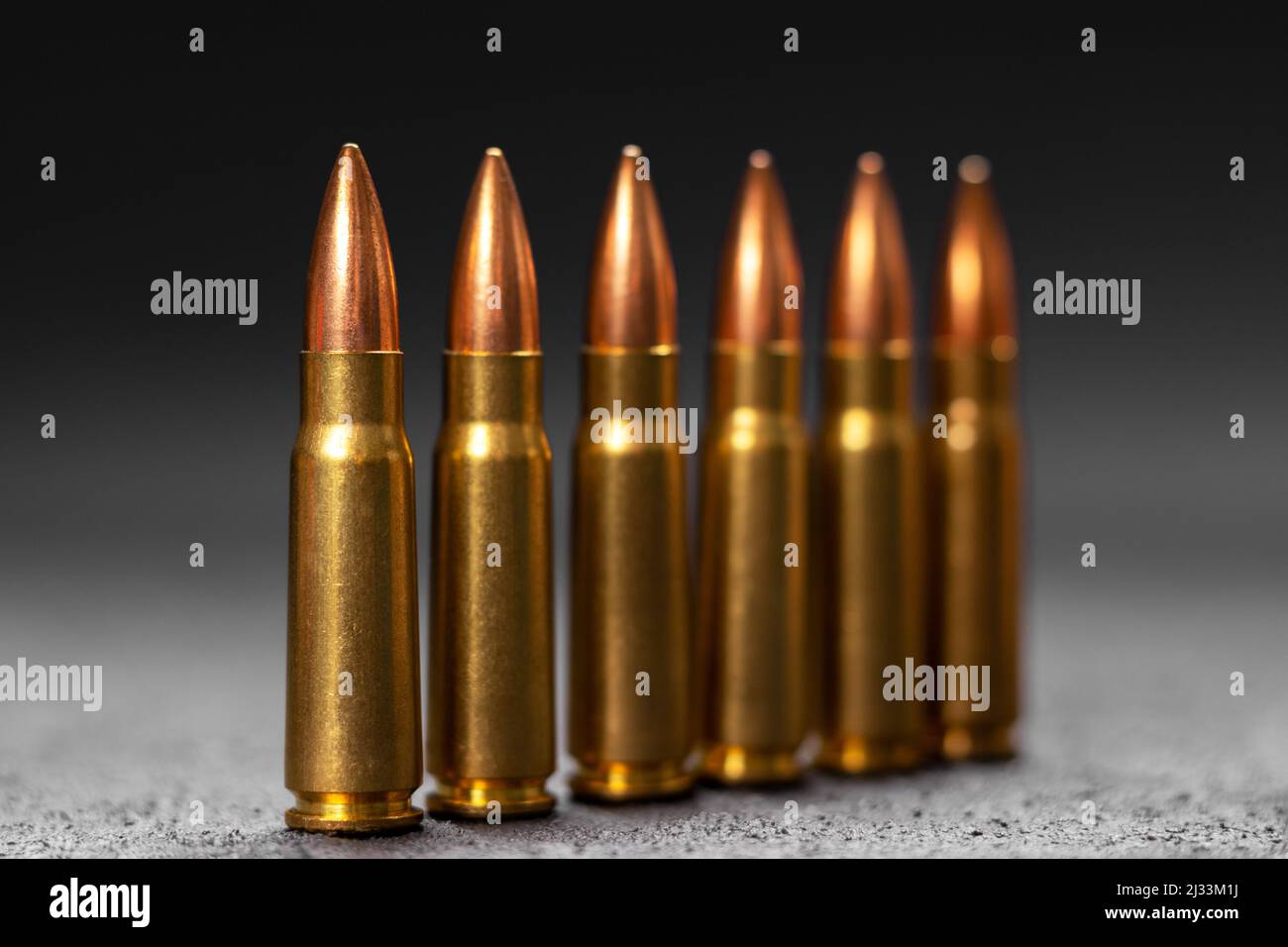Bullets on gray background. Cartridges 7.62 caliber for Kalashnikov ...