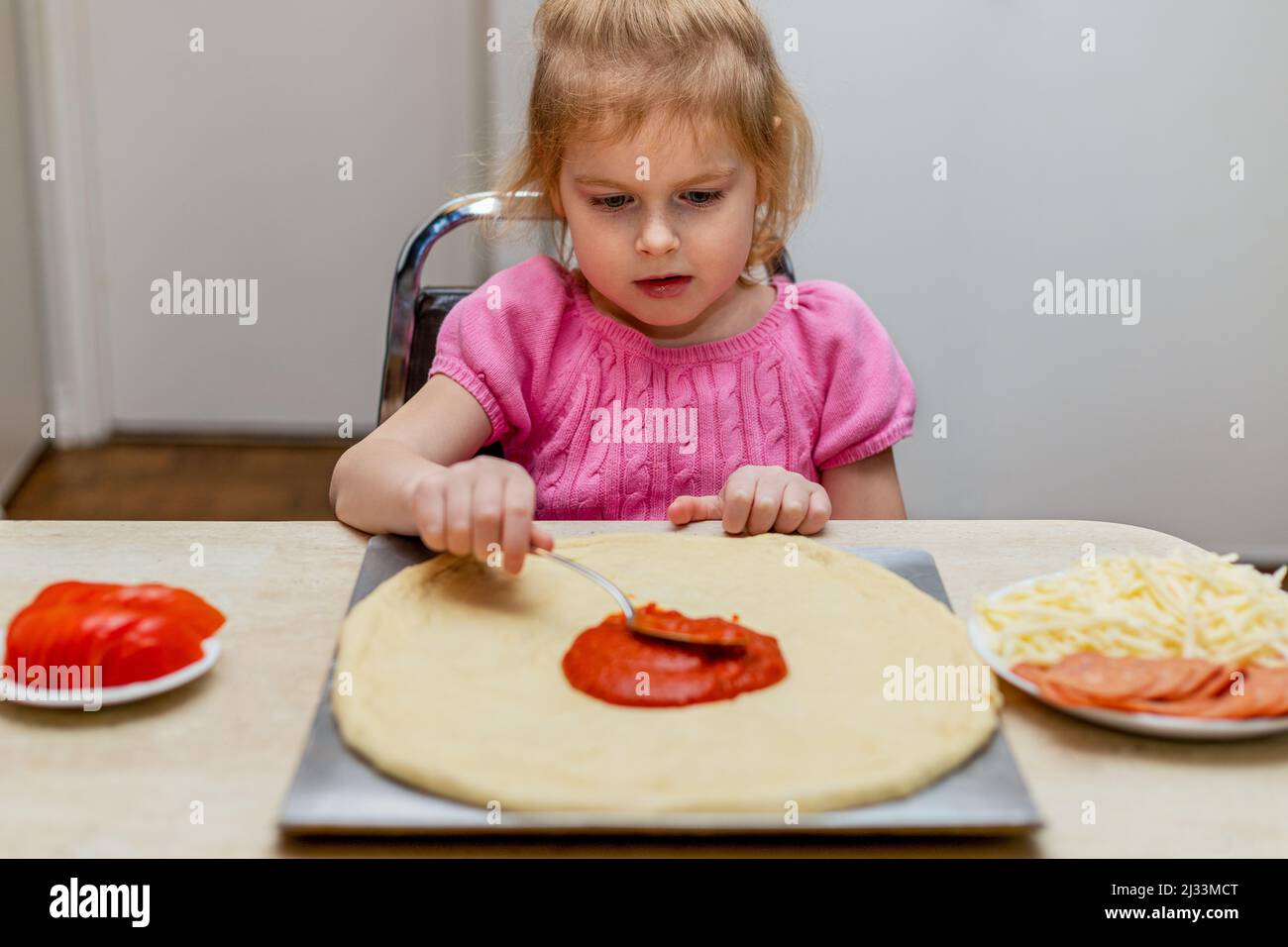 Little girl cooking pizza. Small kid learning to cook meal. Child ...