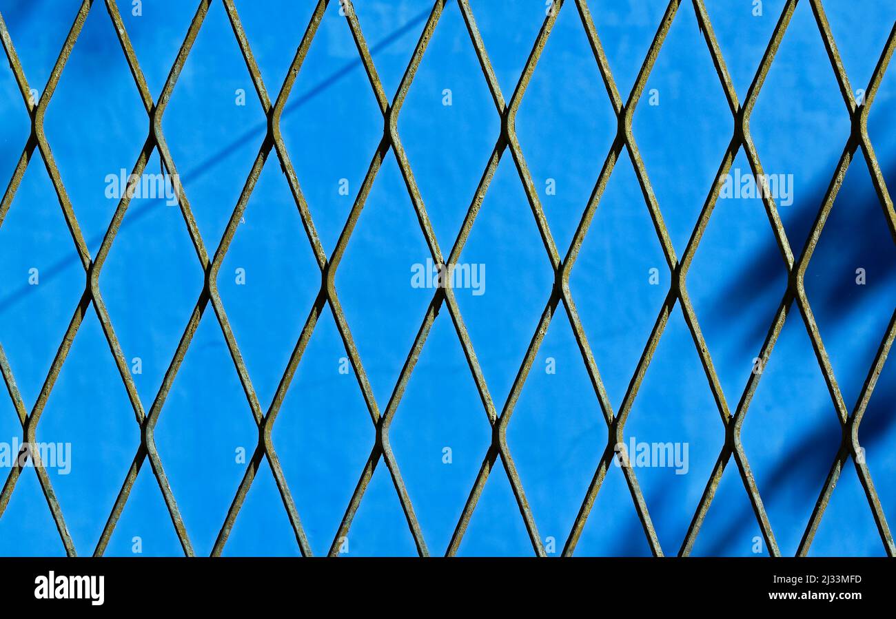 Green mesh, rhombus grid on blue background Stock Photo - Alamy