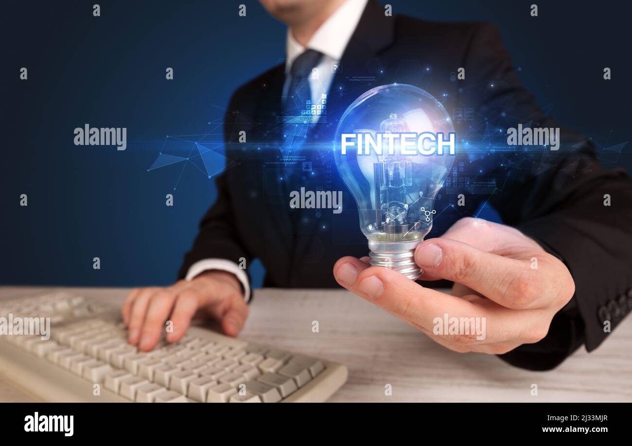 Businessman holding a light bulb Stock Photo - Alamy