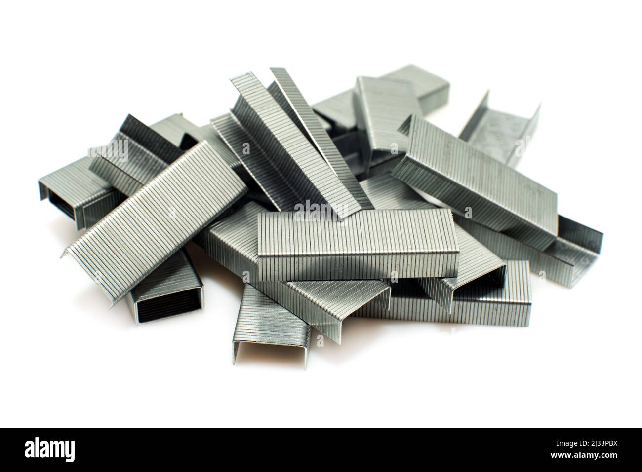 Staples from a stapler on a white background. Isolate of a bunch of ...