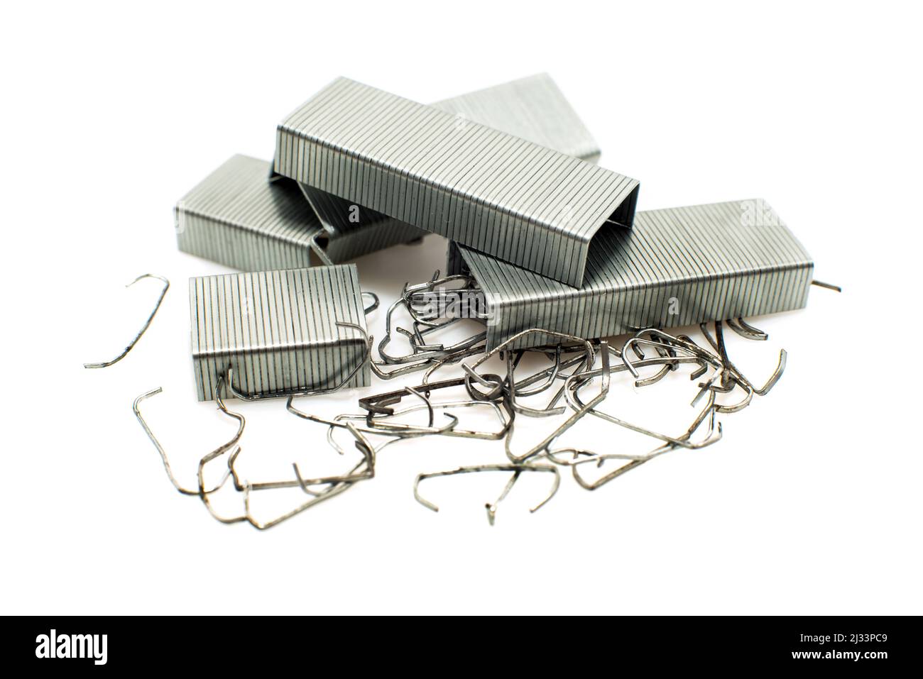 Staples from a stapler on a white background. Isolate of a bunch of ...