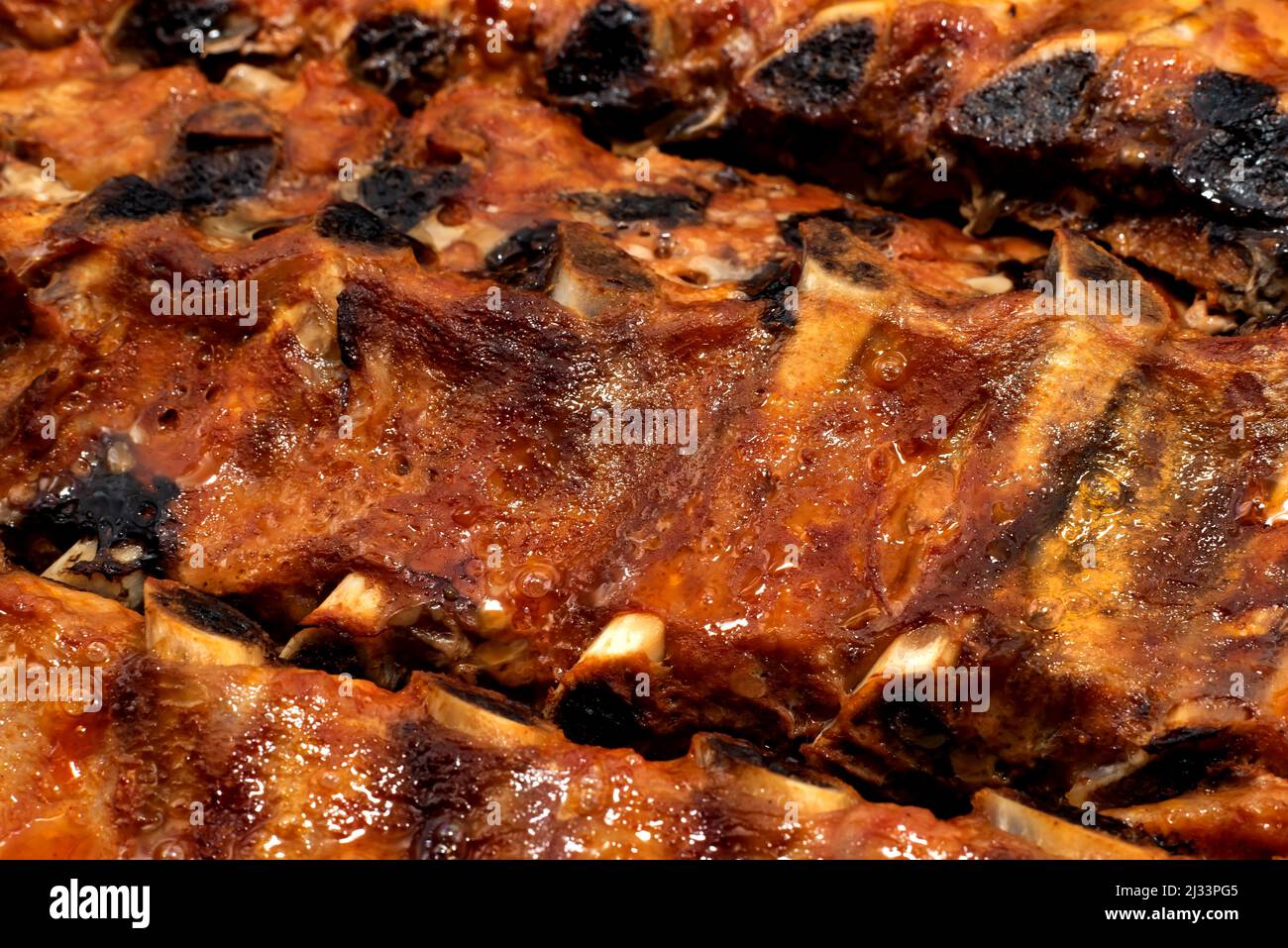 Fried ribs on a metal pan in fat. Meat products from beef Stock Photo ...