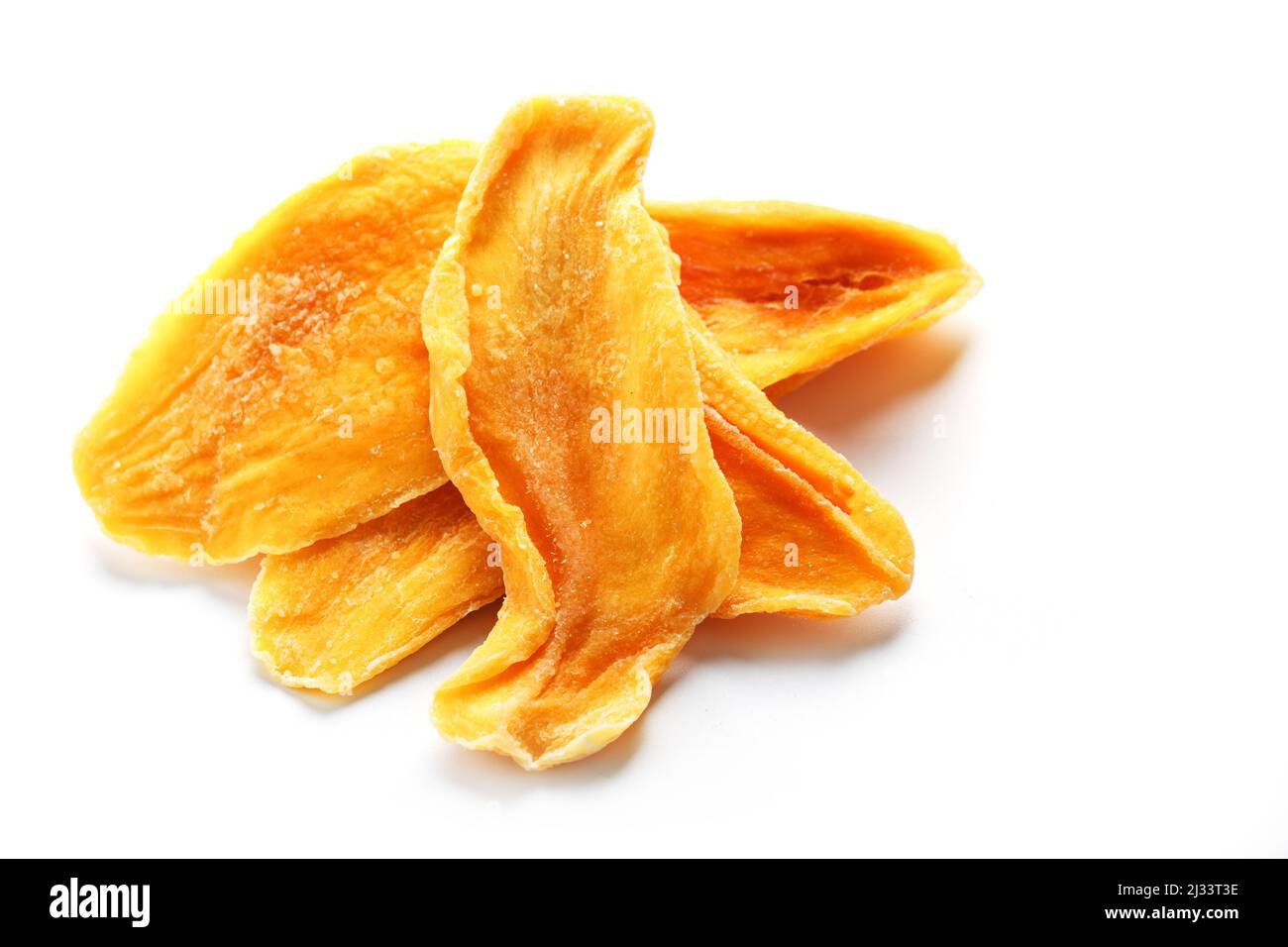 Dried sweet mango fruit slices as textural orange background in full ...