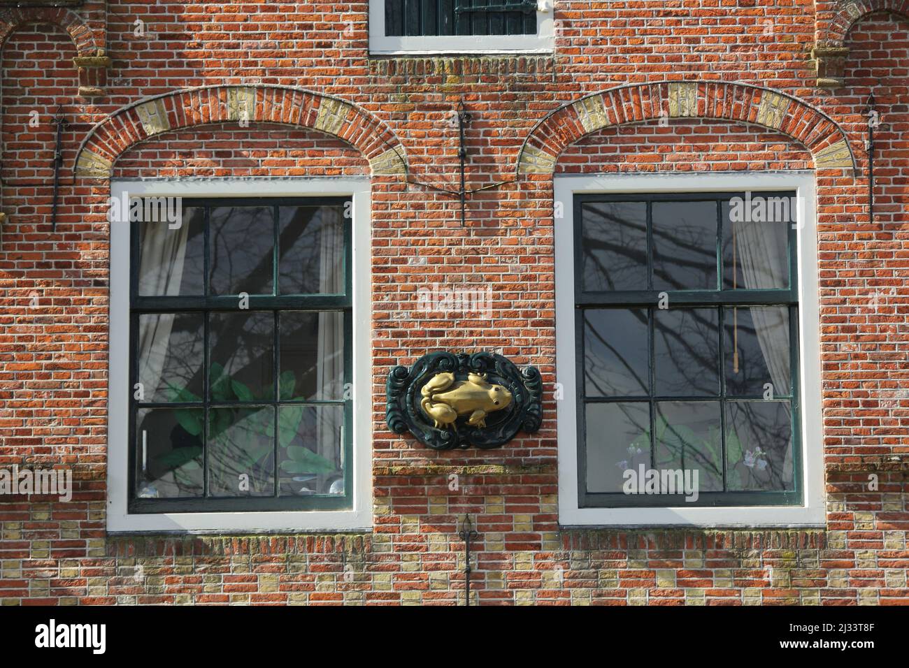 Brick house wall with window and frog figure in Den Burg, Texel ...