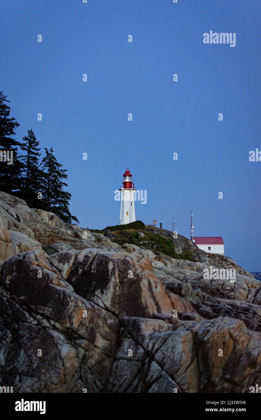 A vertical shot of a lighthouse on a rocky place Stock Photo - Alamy
