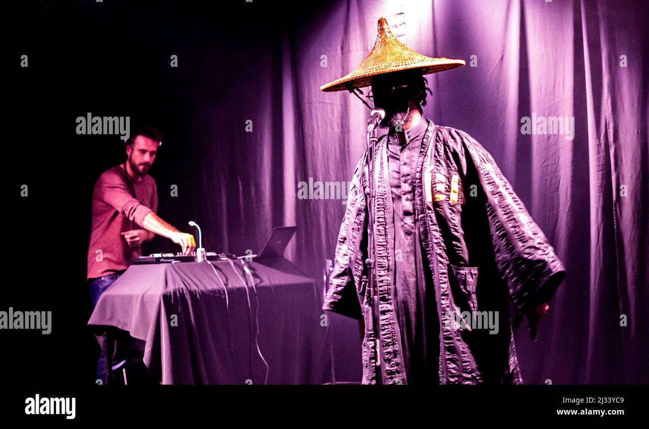 A male singer in a traditional costume performing live on the stage ...