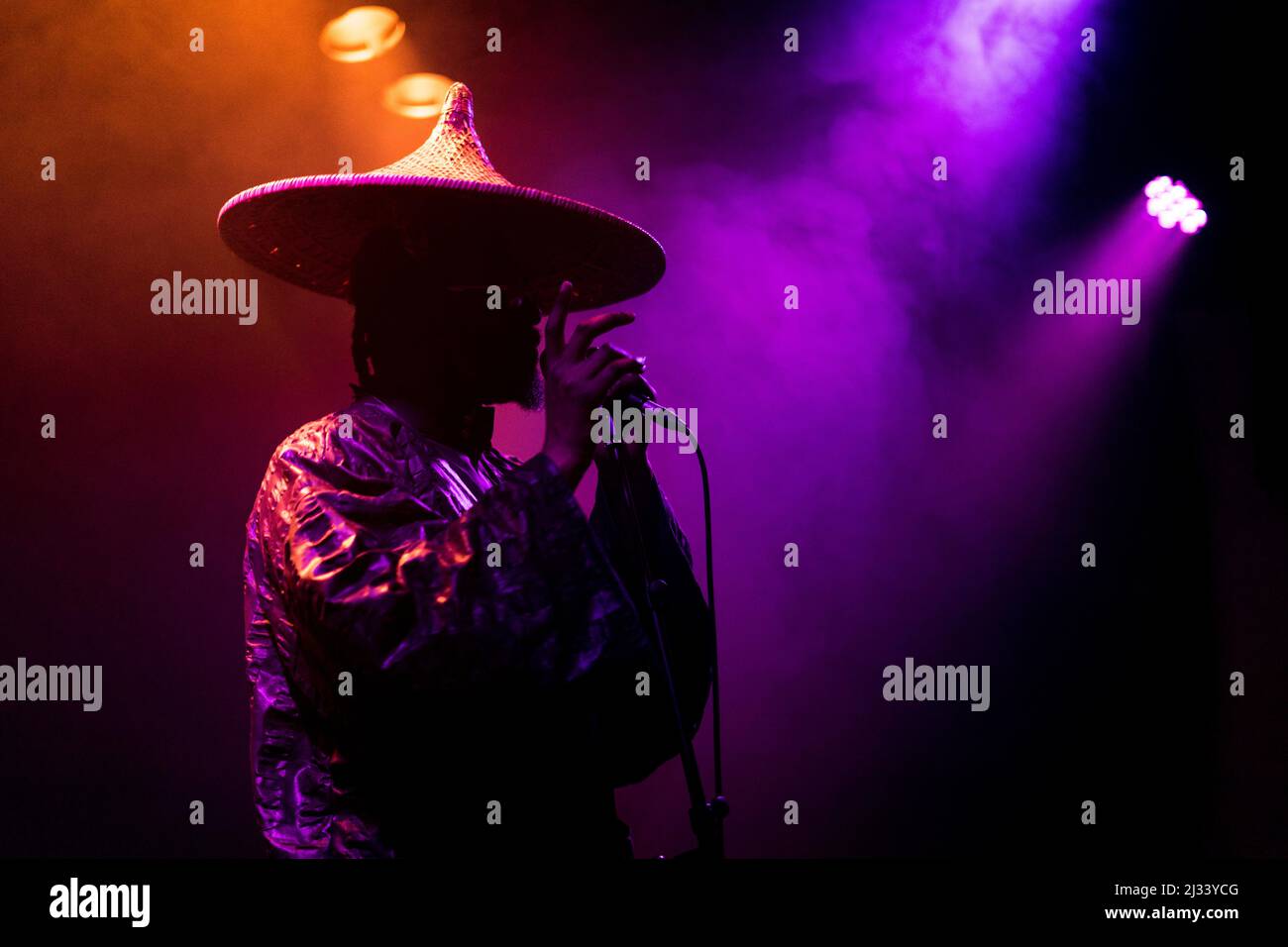 A male singer in a traditional costume performing live on the stage ...