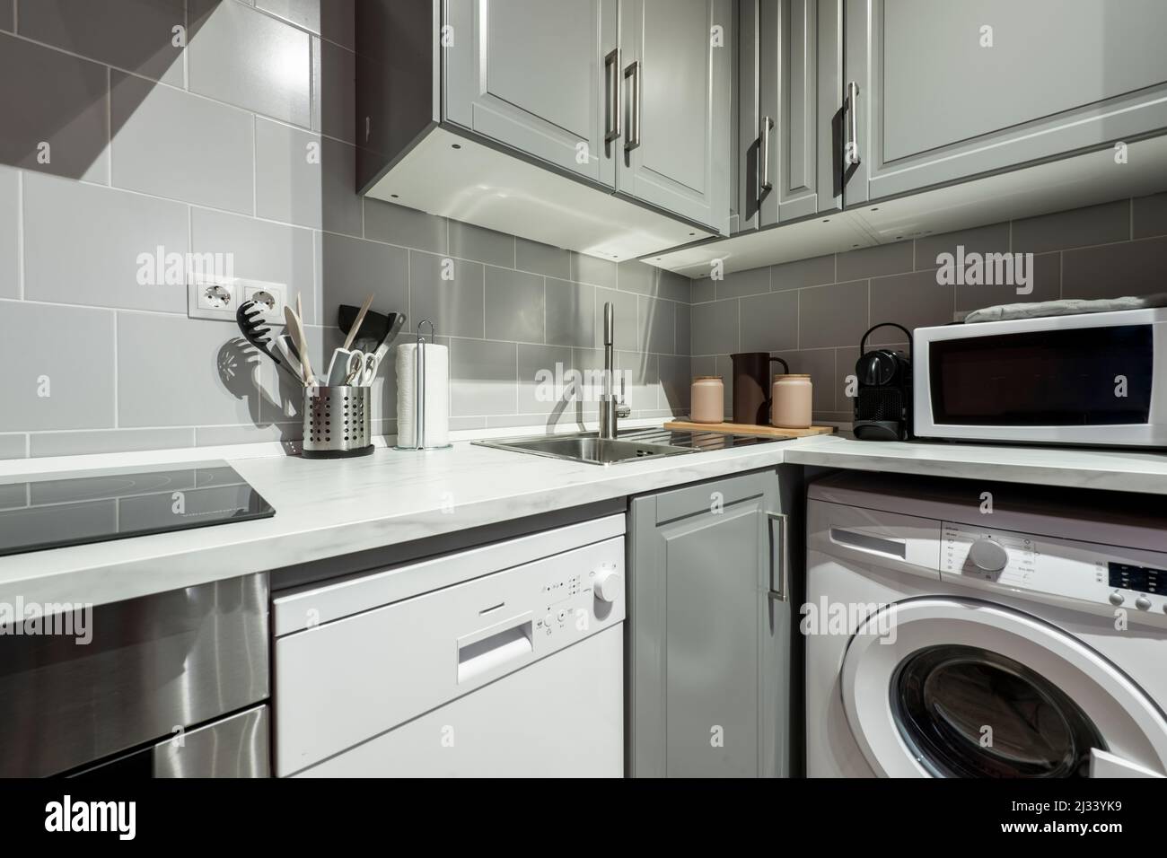 Open kitchen with white appliances, dishwasher, washing machine and ...