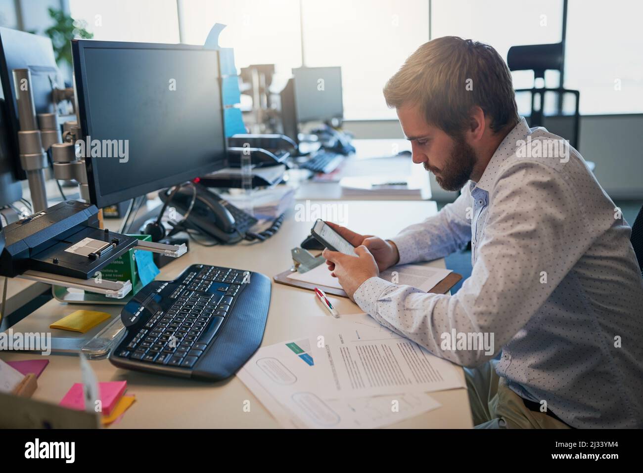 Reading an important message. Shot of a focused young businessman ...