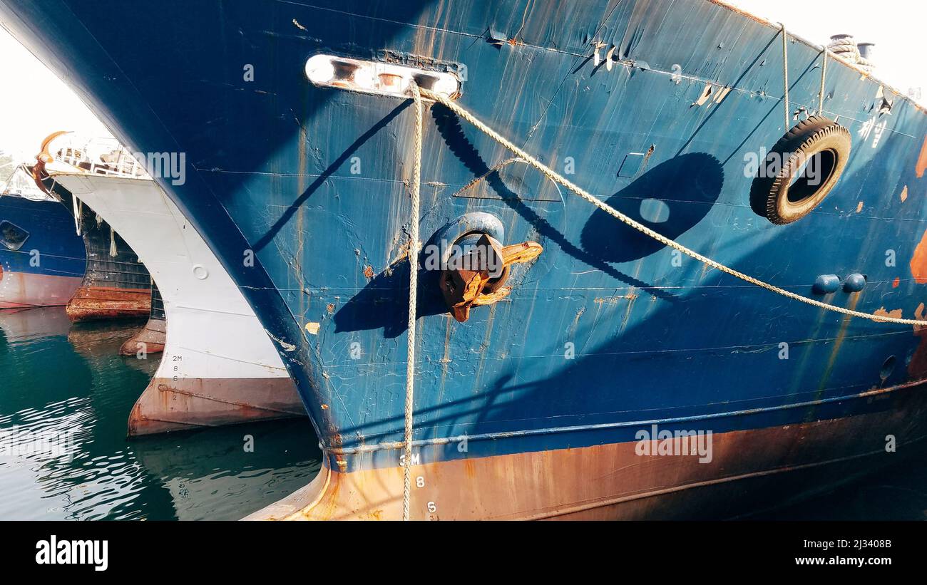 An old, blue ship on the port in daylight Stock Photo - Alamy