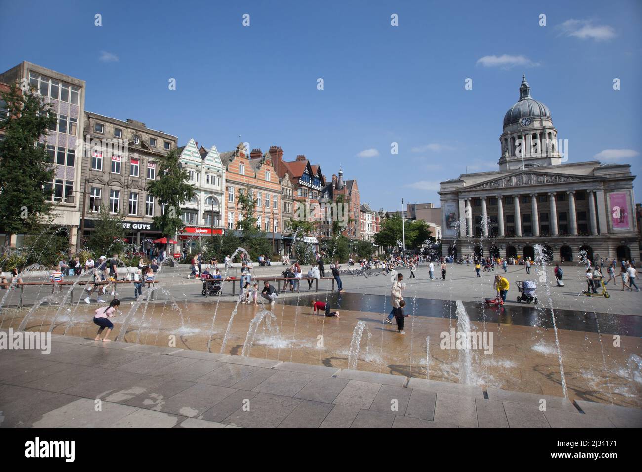 Children playing in the water fountain at Old Market Square in ...
