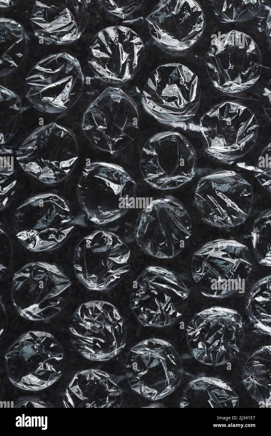 Packing bubble wrap for parcels on a Black background in full screen ...