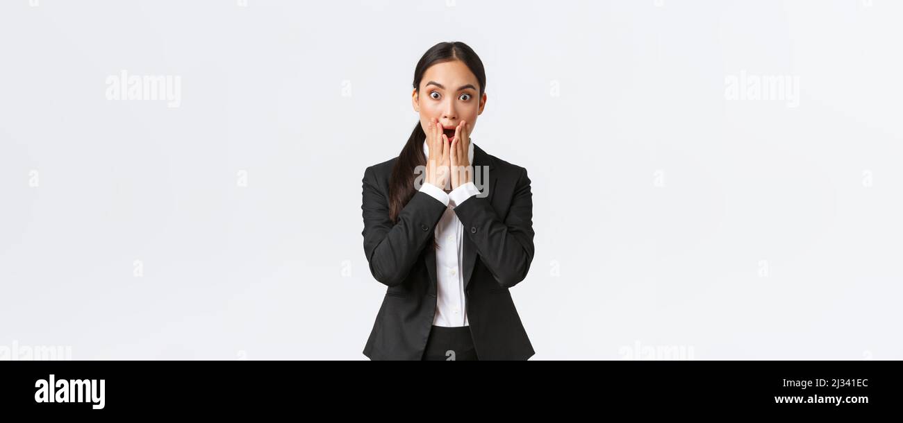 Shocked concerned asian businesswoman facing troublesome situation ...