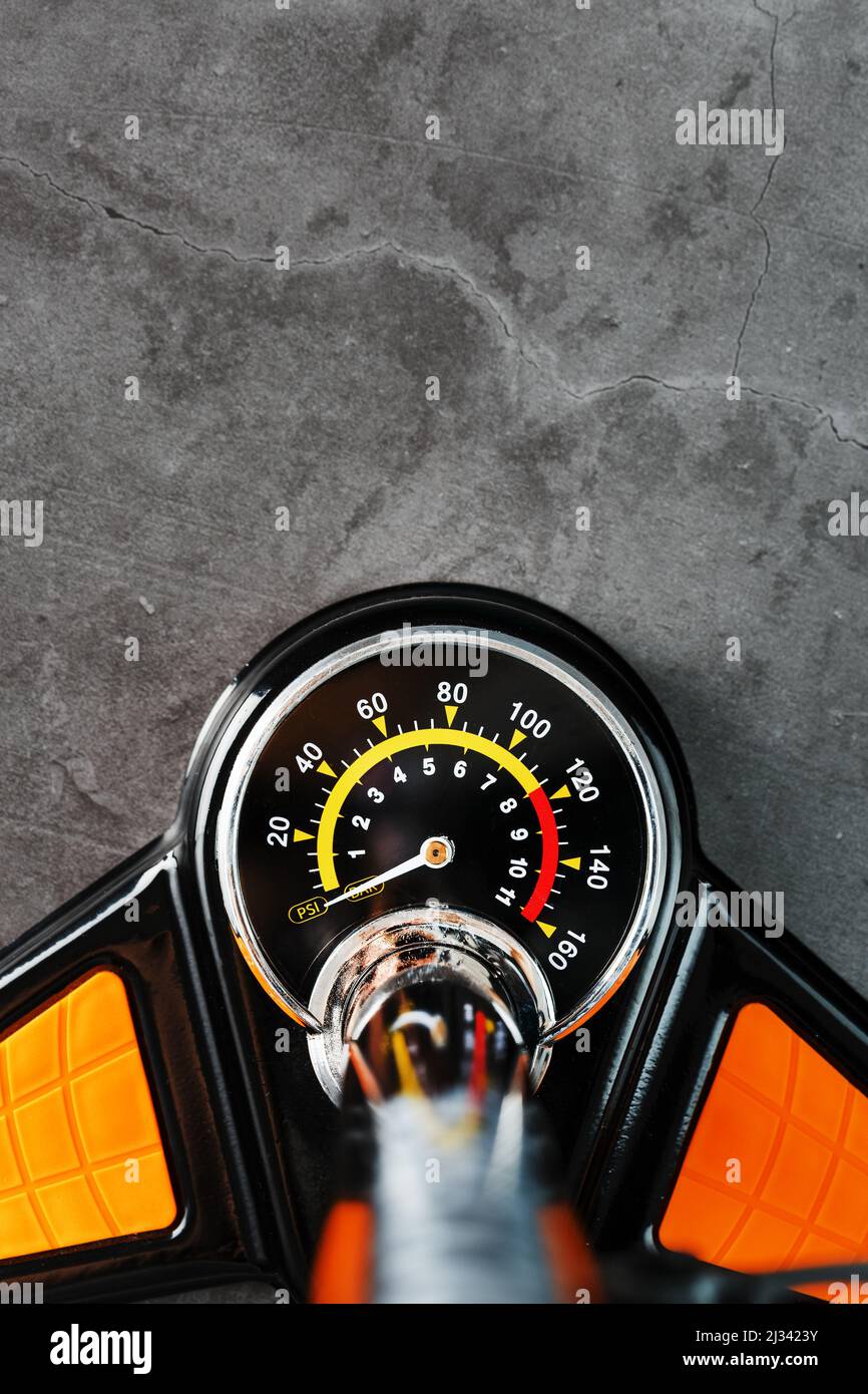 Air pump manometer for monitoring tire pressure on a dark background ...
