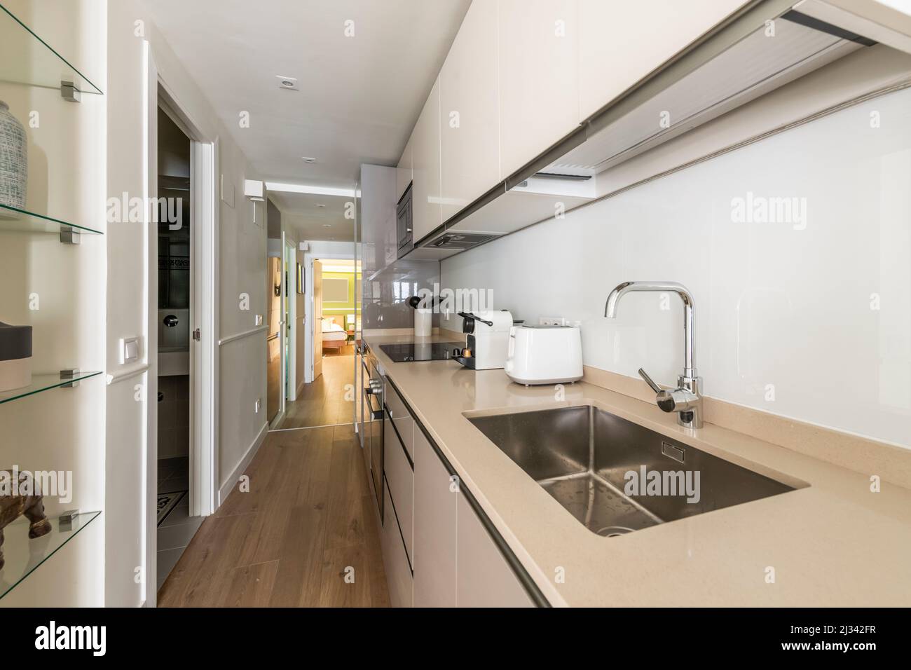 Open kitchen as a passageway in a vacation rental home with gray ...