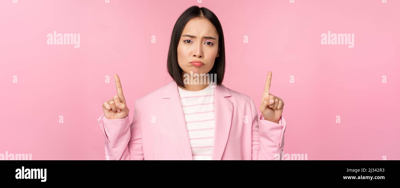 Sad asian business woman, professional corporate manager pointing ...
