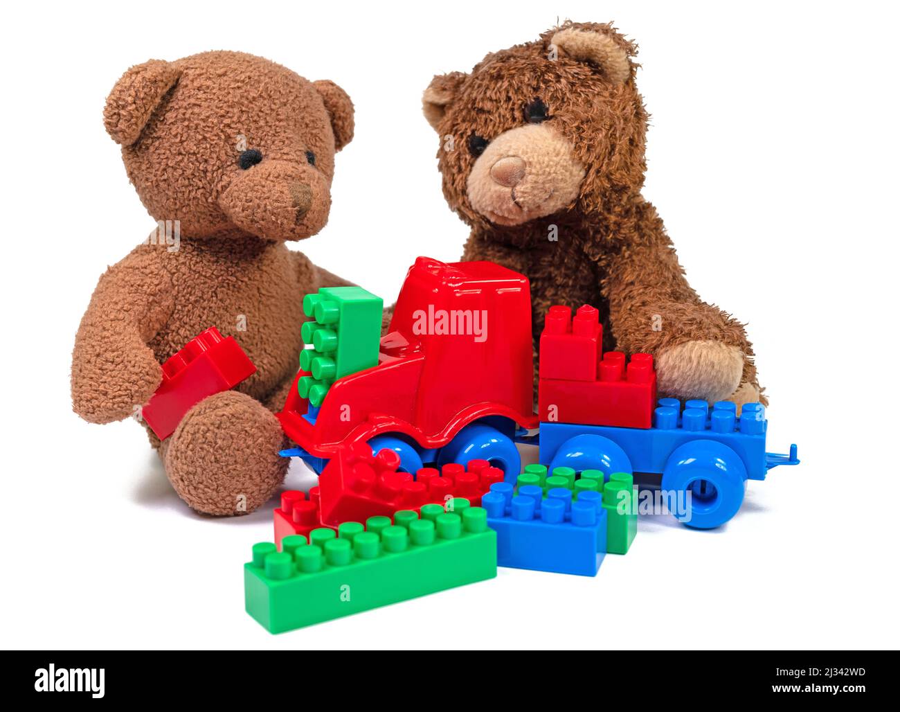 Plush bears and plastic building blocks against a white background ...