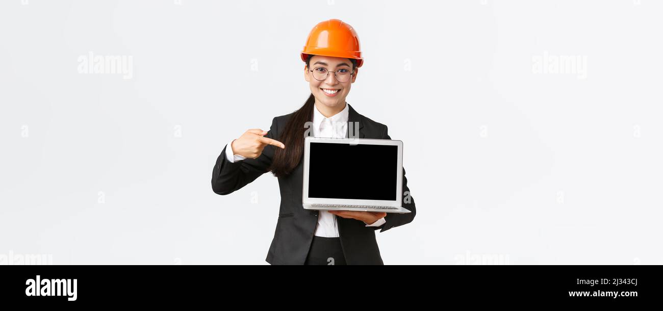 Smiling pleased asian female chief engineer showing chart with ...