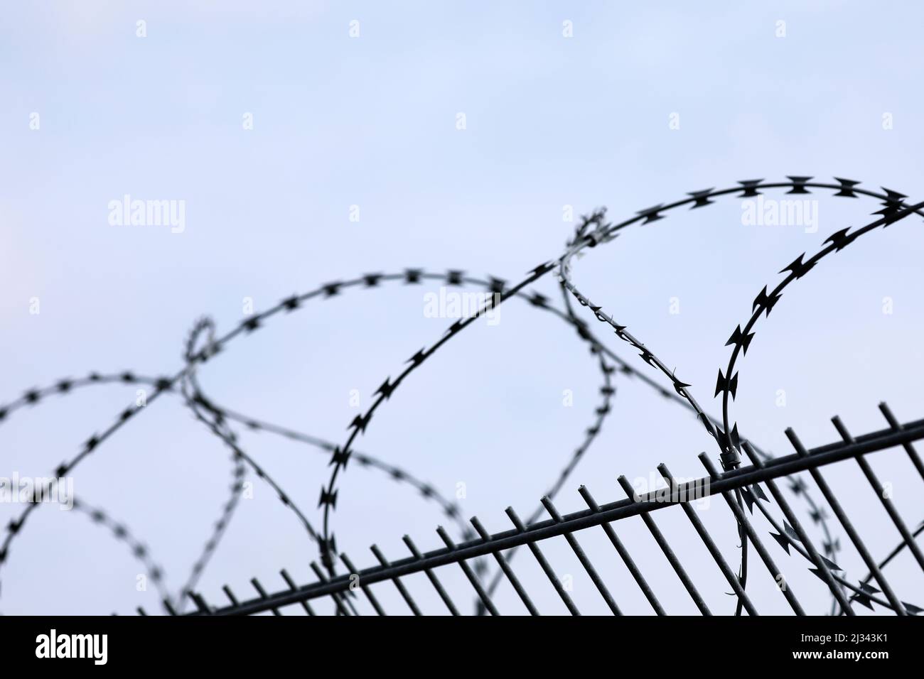 Fence metal with barbed wire Stock Photo - Alamy