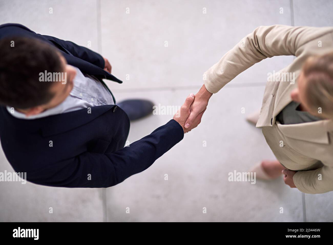 The handshake seals the deal. High angle shot of two professional ...