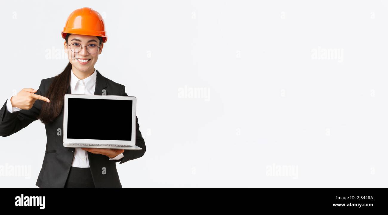 Smiling pleased asian female chief engineer showing chart with ...