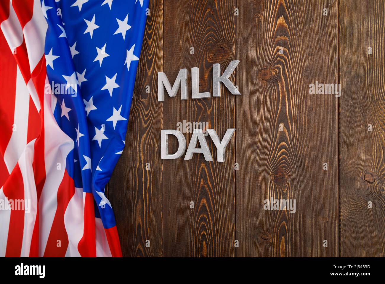 the word MLK day laid with silver metal letters on wooden surface with ...