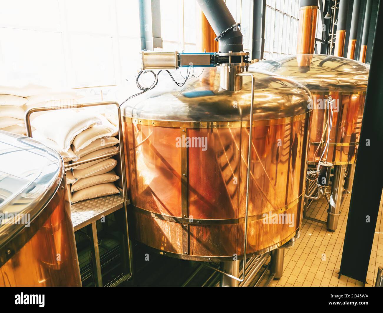 Brewery equipment. Brew manufacturing. Round cooper storage tanks for ...