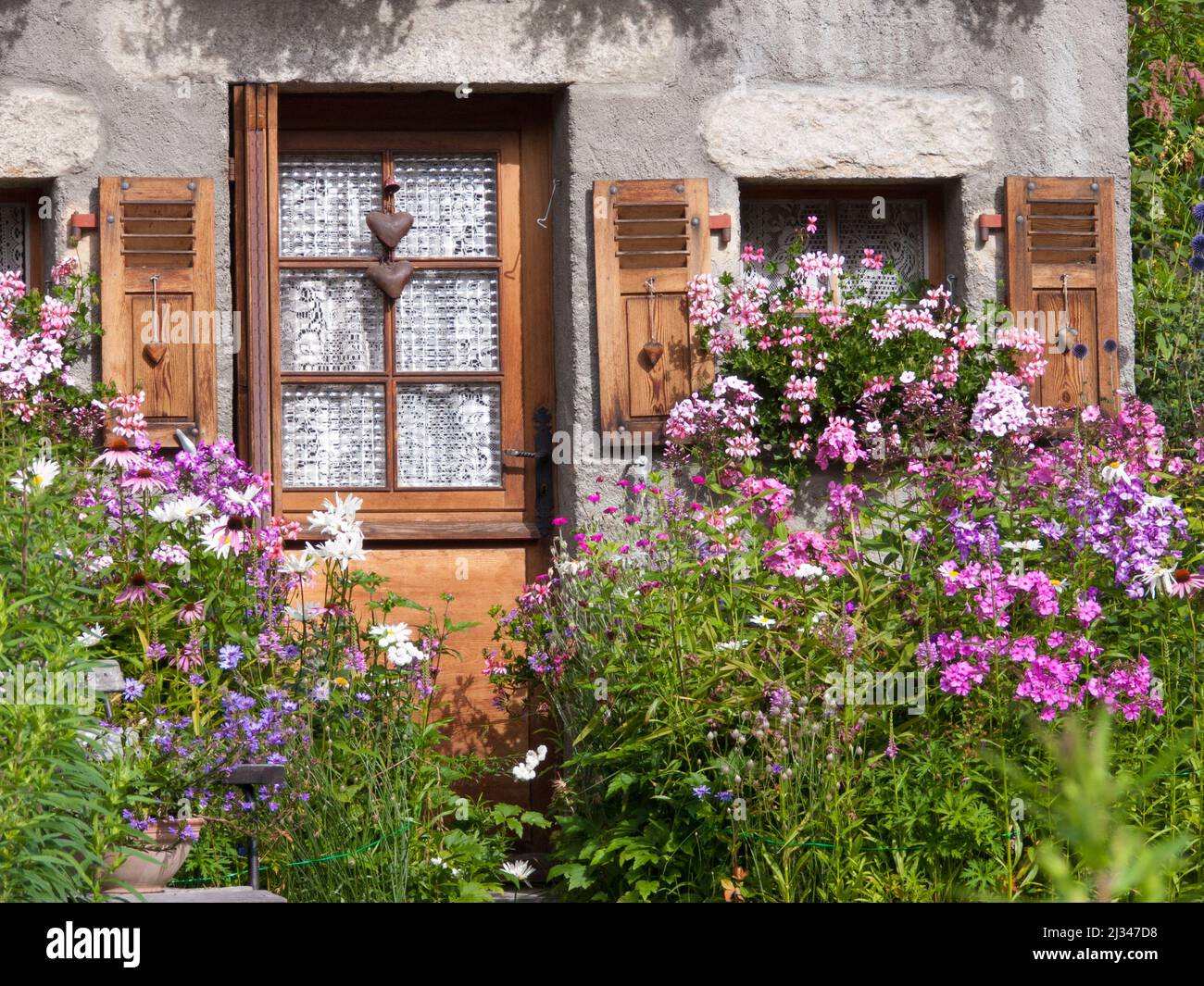 A bright summer day in Chamonix, France with lush greenery surrounding ...