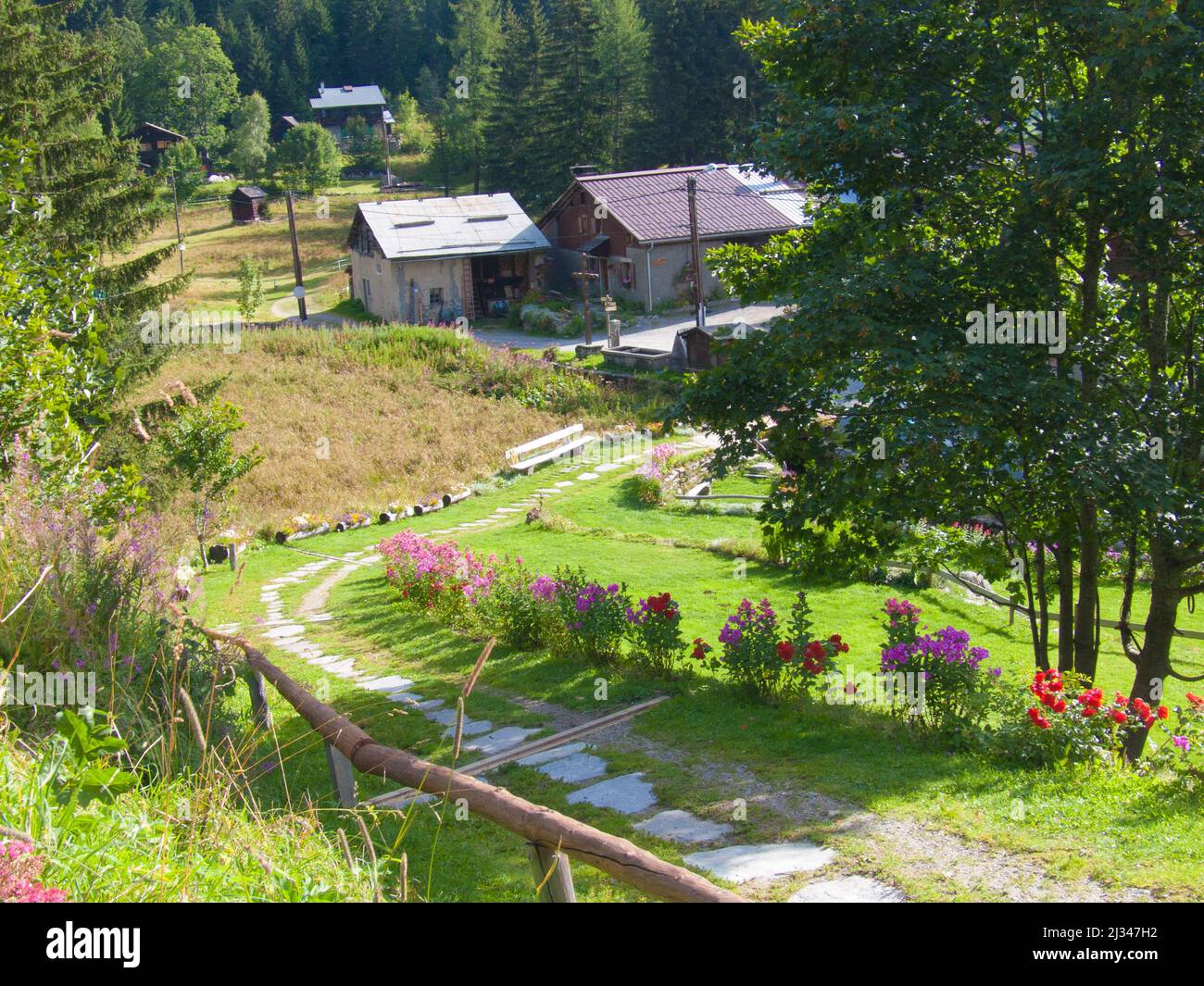 A bright summer day in Chamonix, France with lush greenery surrounding ...