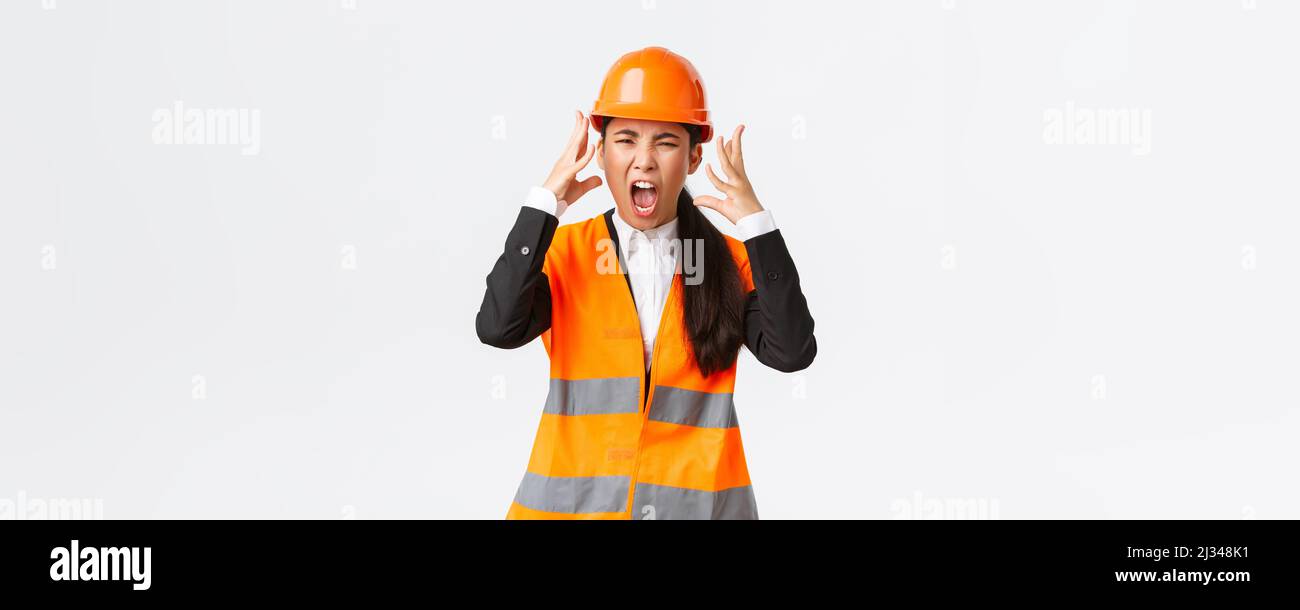 Mad and outraged asian female chief engineer, construction manager ...
