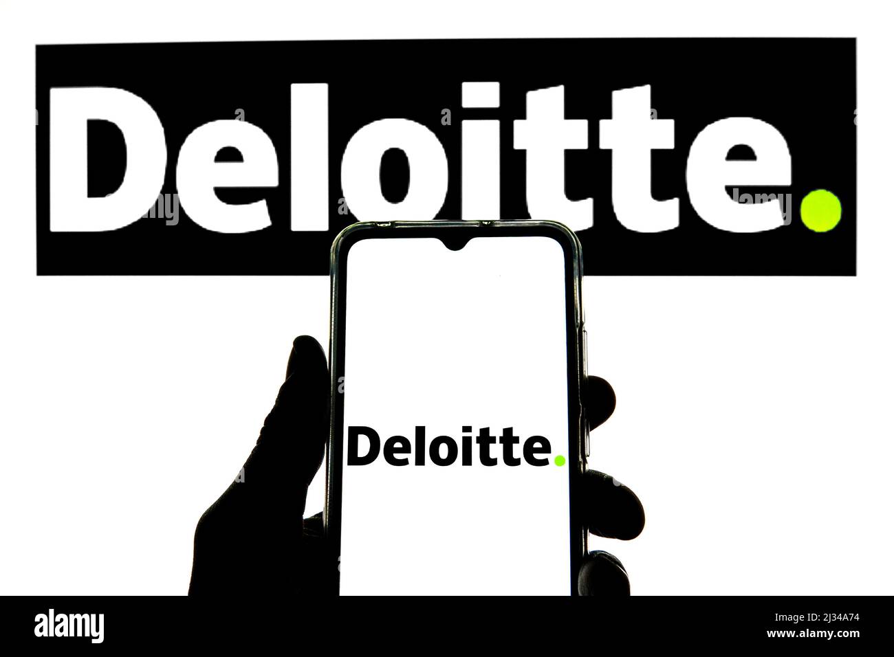 In this photo illustration a Deloitte logo seen displayed on a ...